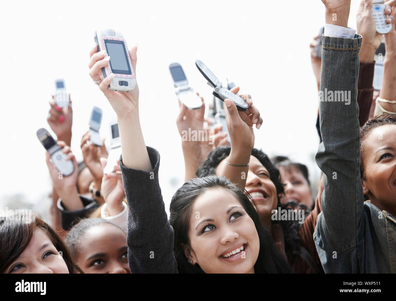 Large group of people and cell phones hi-res stock photography and ...