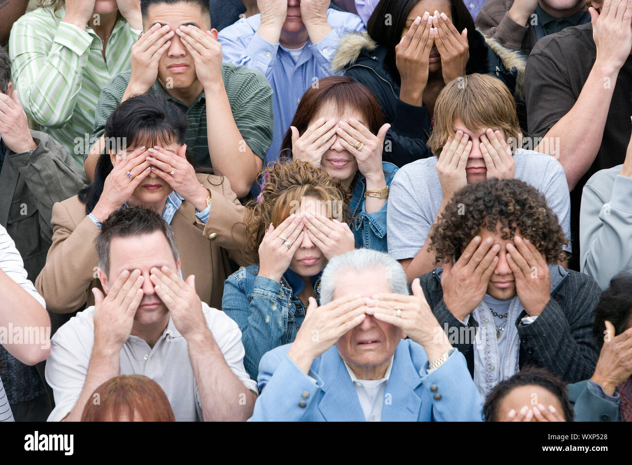 Crowd covering eyes Stock Photo - Alamy