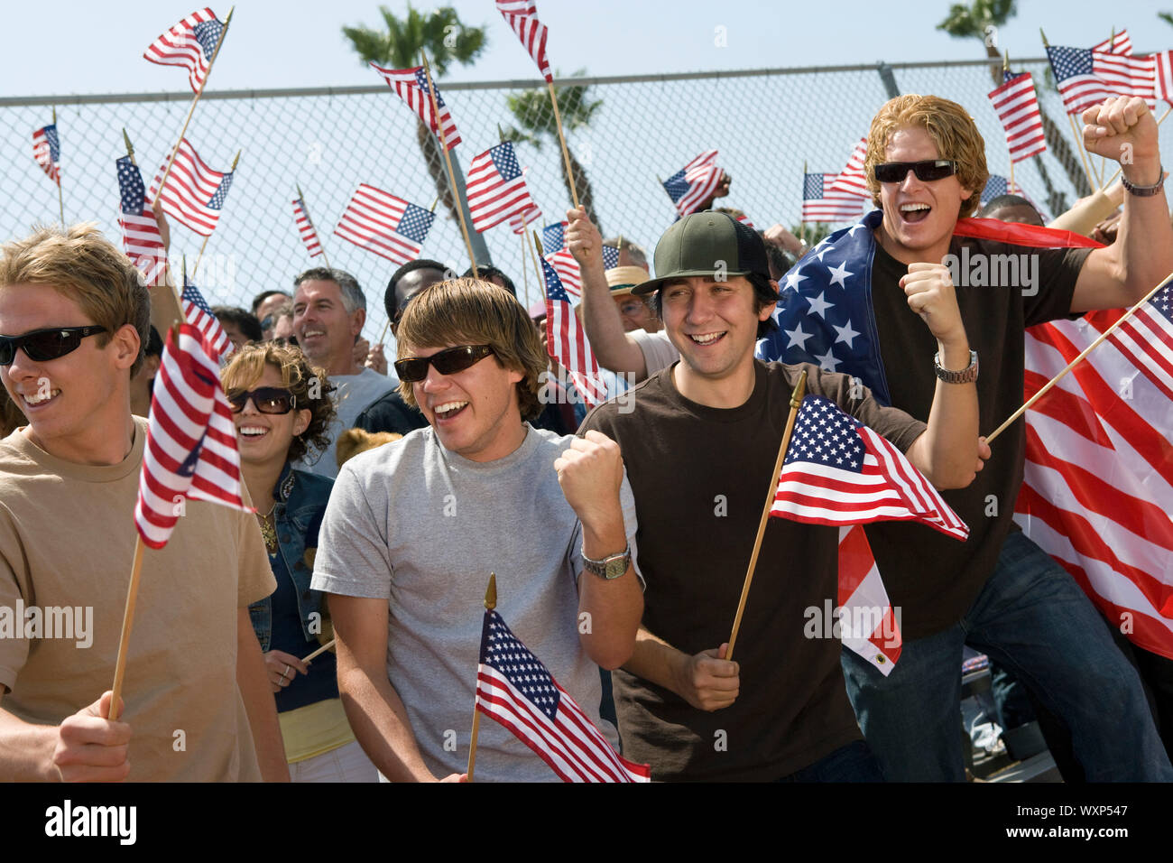 Crowd holding up American flags Stock Photo - Alamy