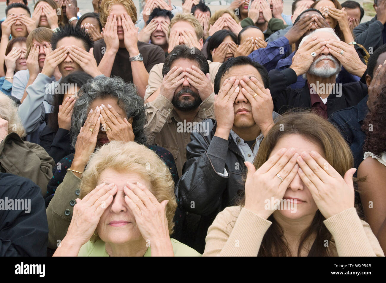 Crowd covering eyes Stock Photo - Alamy