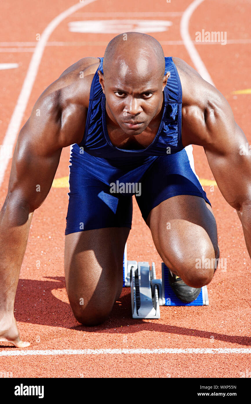 Runner at Starting Block Stock Photo - Alamy