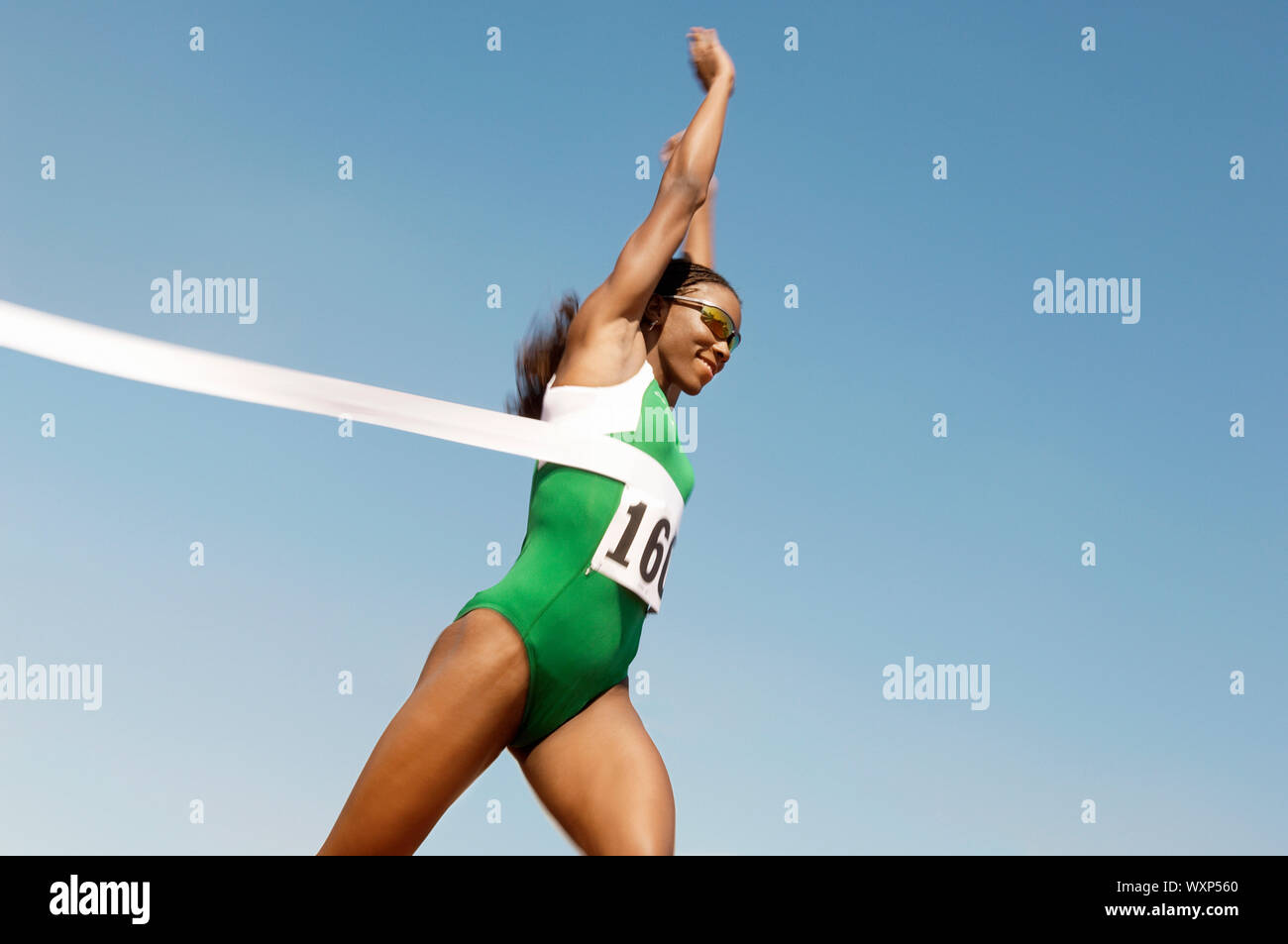 Runner Breaking Finish Line Tape Stock Photo - Alamy