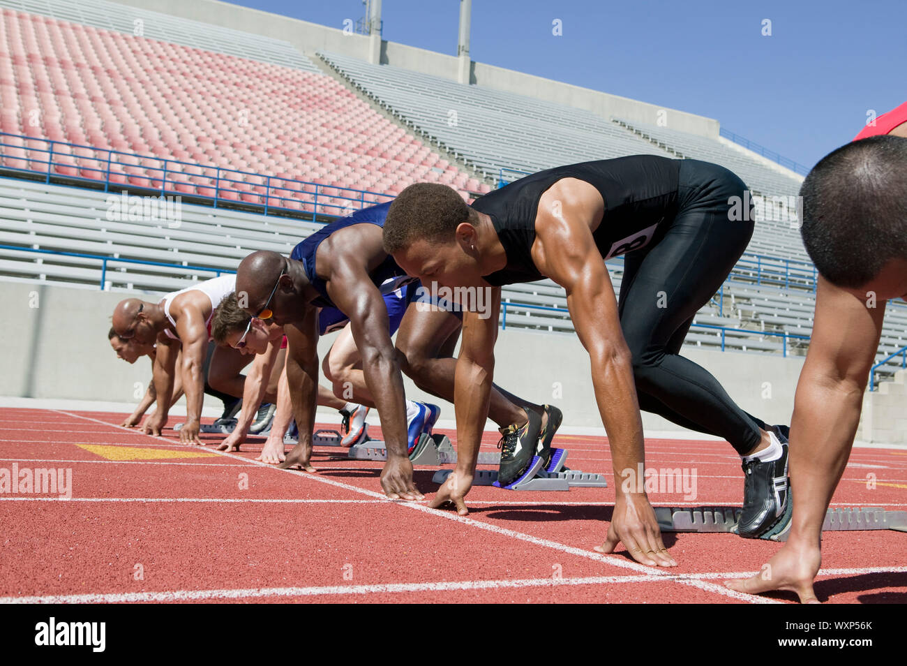 Male sprinters in starting blocks hi-res stock photography and images ...