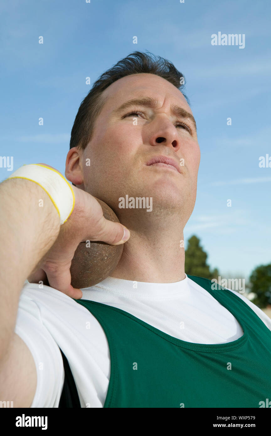 Male shot putter holding shot Stock Photo - Alamy
