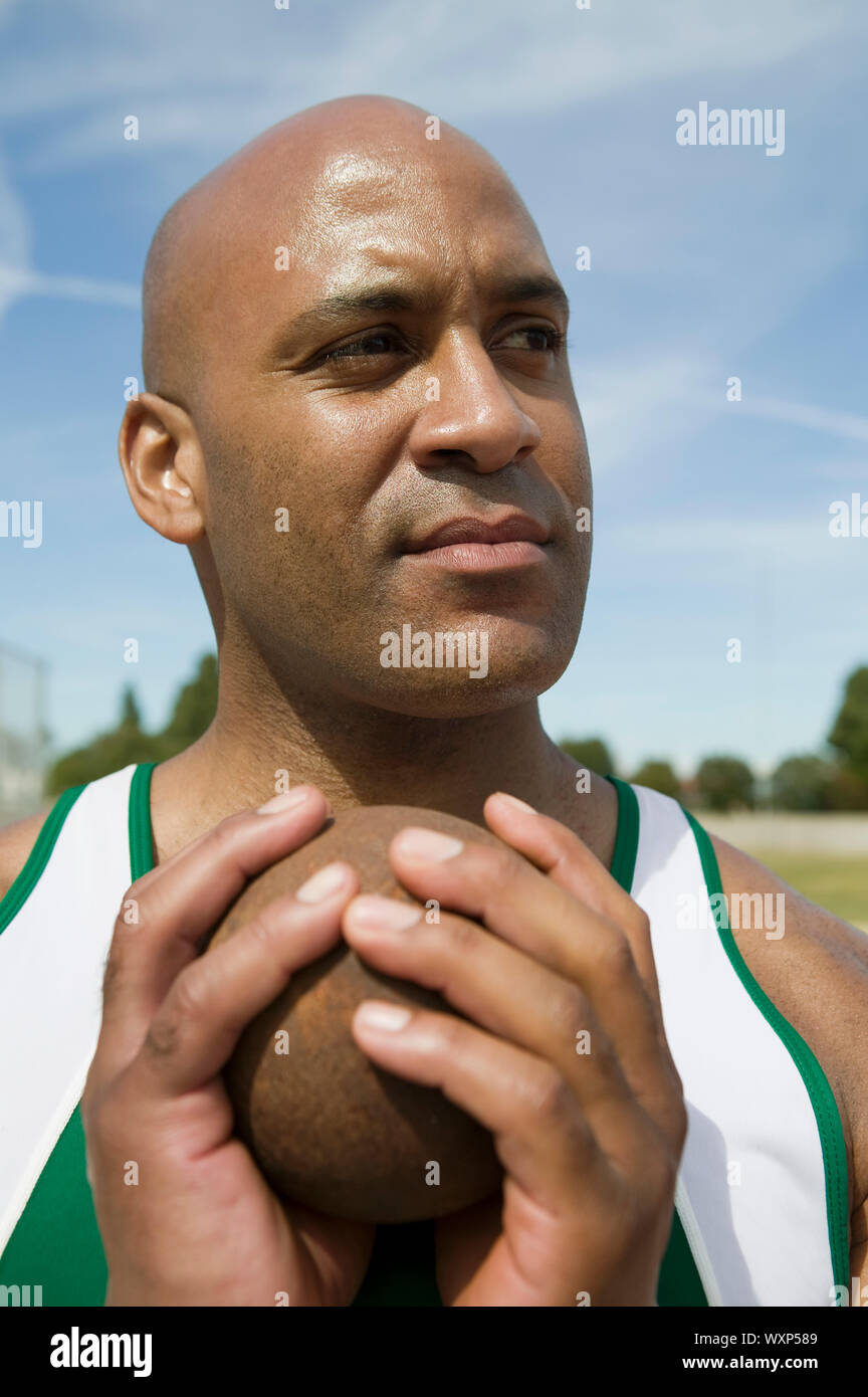Male shot putter gripping shot Stock Photo - Alamy