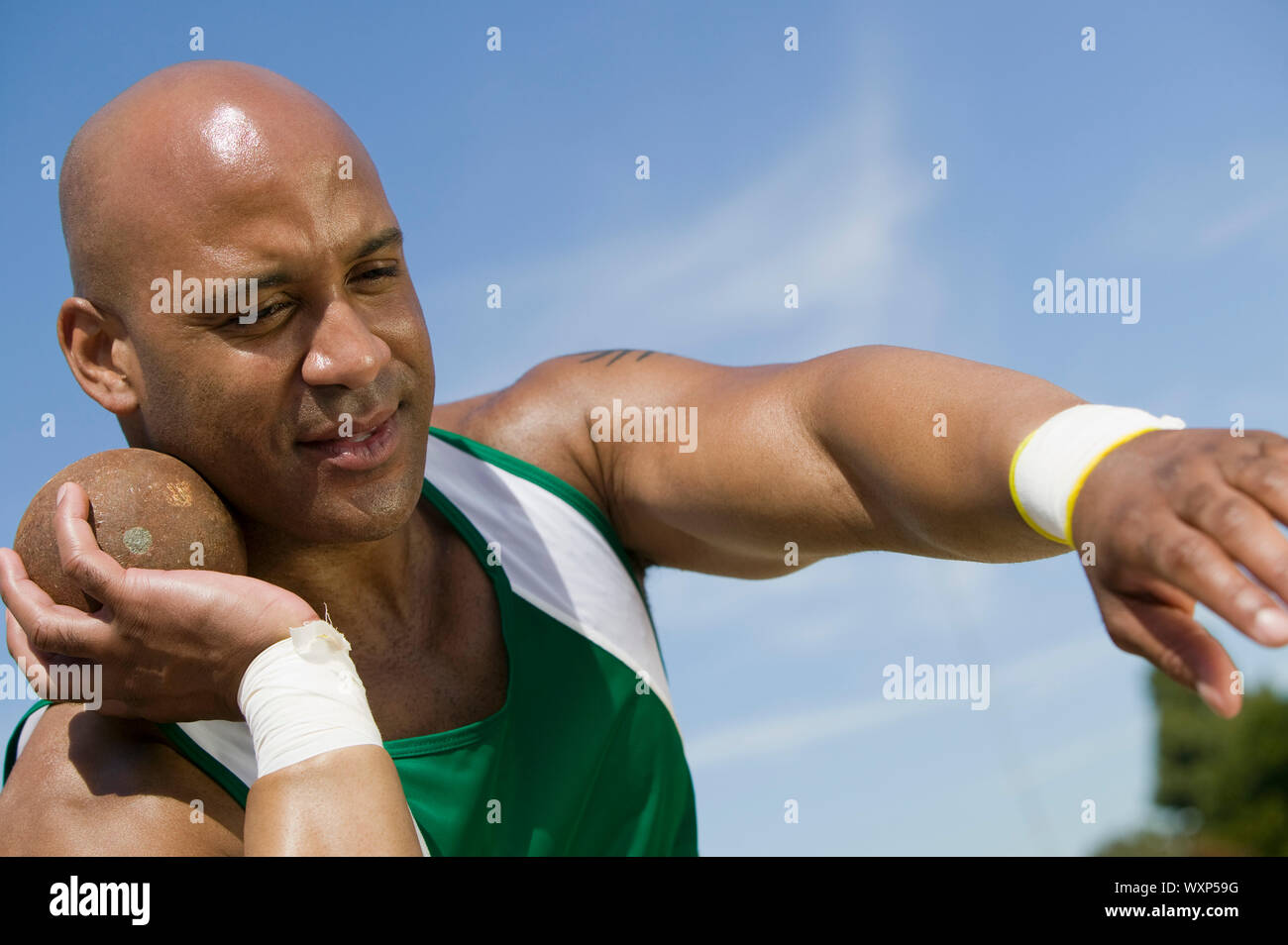Male shot putter holding shot Stock Photo - Alamy