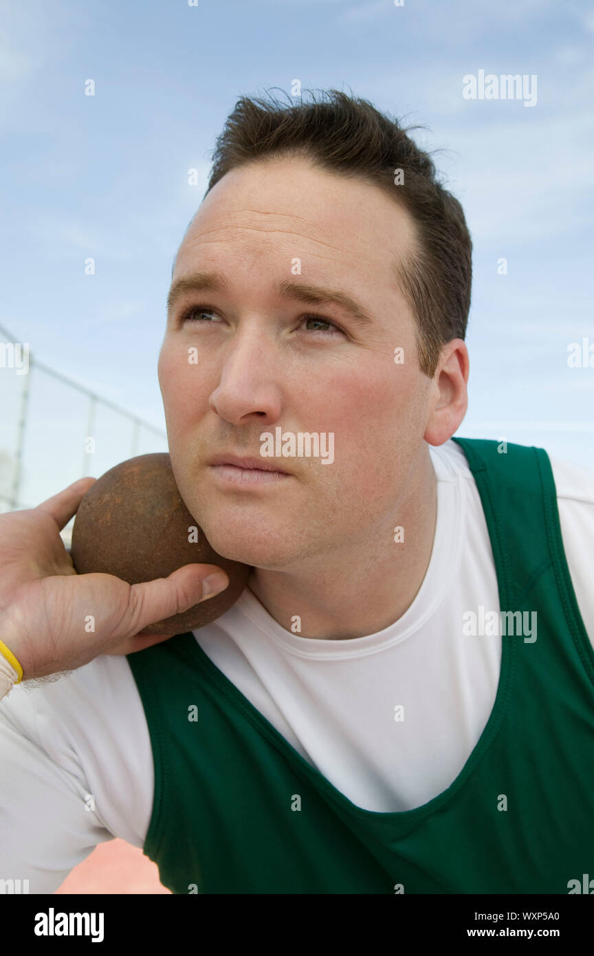 Male shot putter holding shot Stock Photo - Alamy
