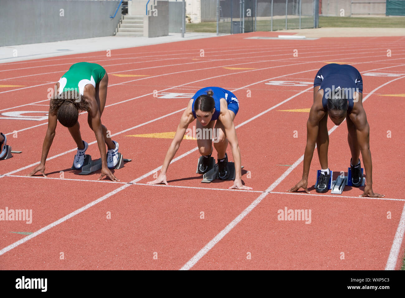 Female athletes in starting blocks hi-res stock photography and images ...
