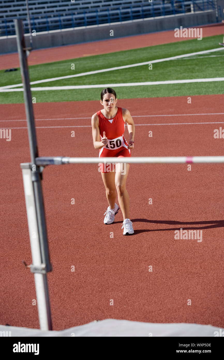 Female athlete high-jumping Stock Photo - Alamy
