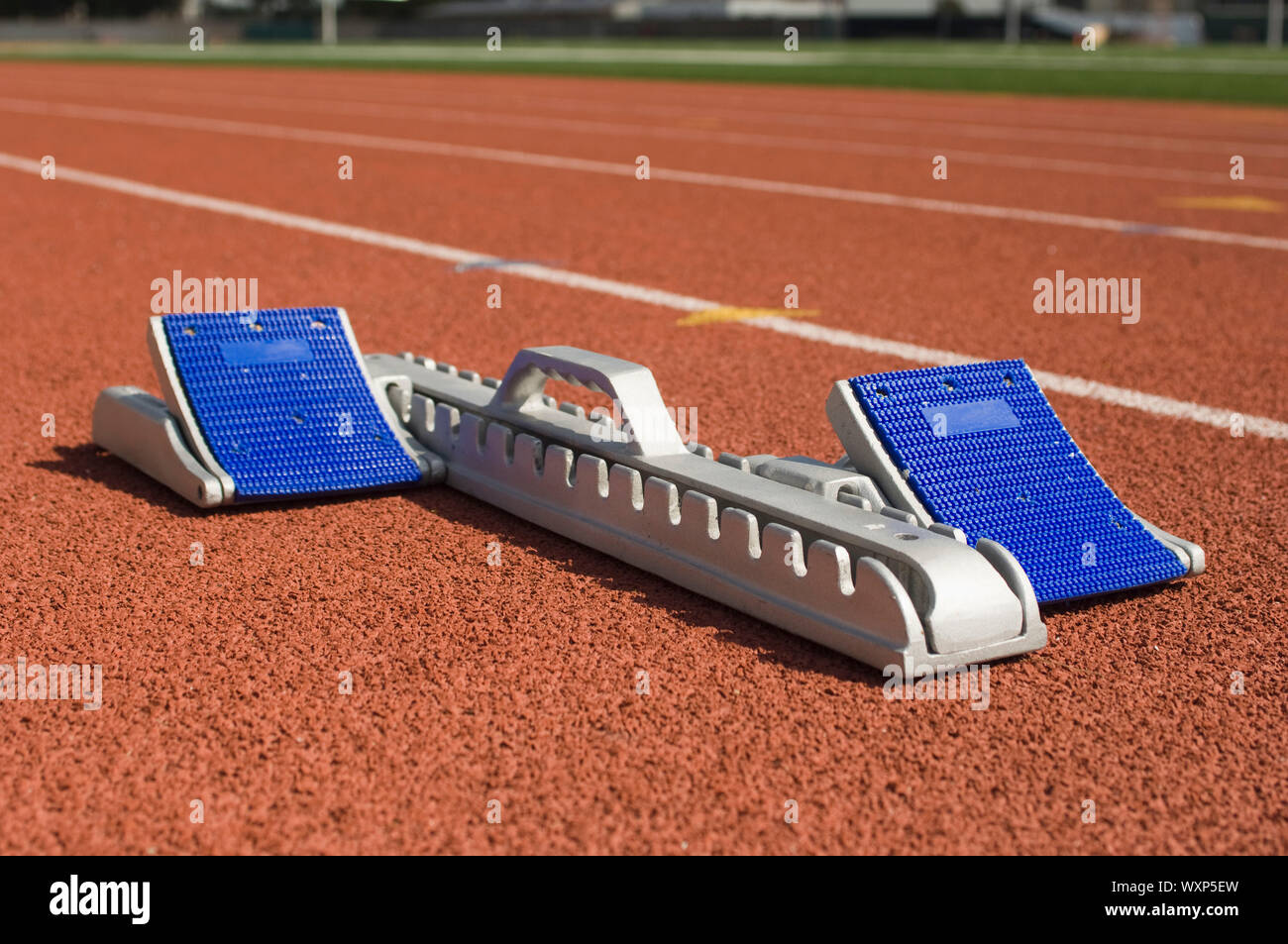 Starting block on running track Stock Photo - Alamy