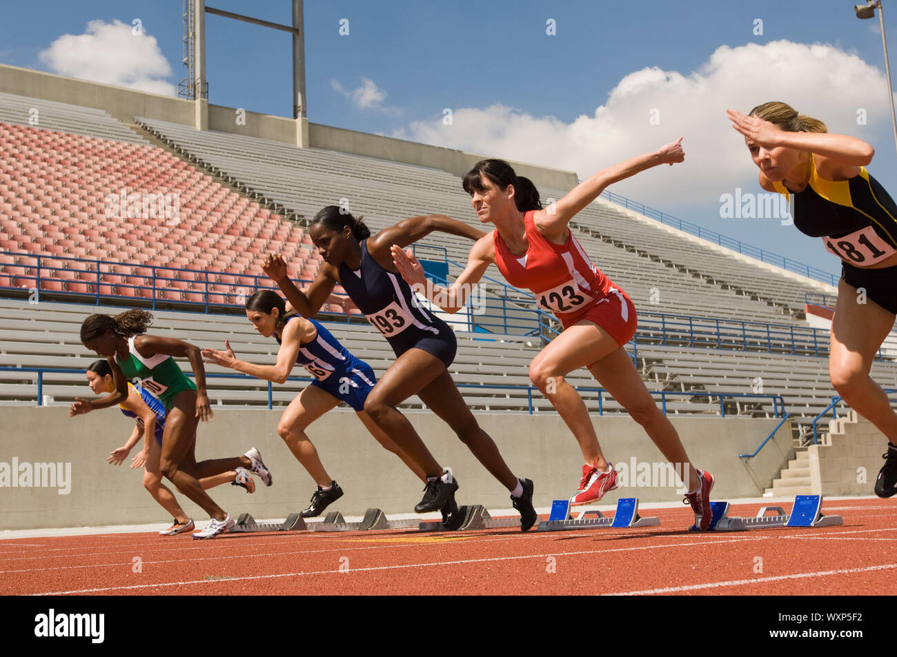 Group of female track athletes sprinting Stock Photo - Alamy