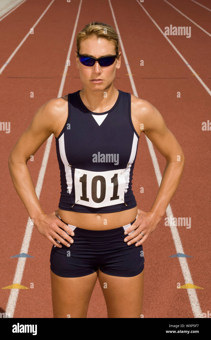 Female track athlete standing on track Stock Photo - Alamy