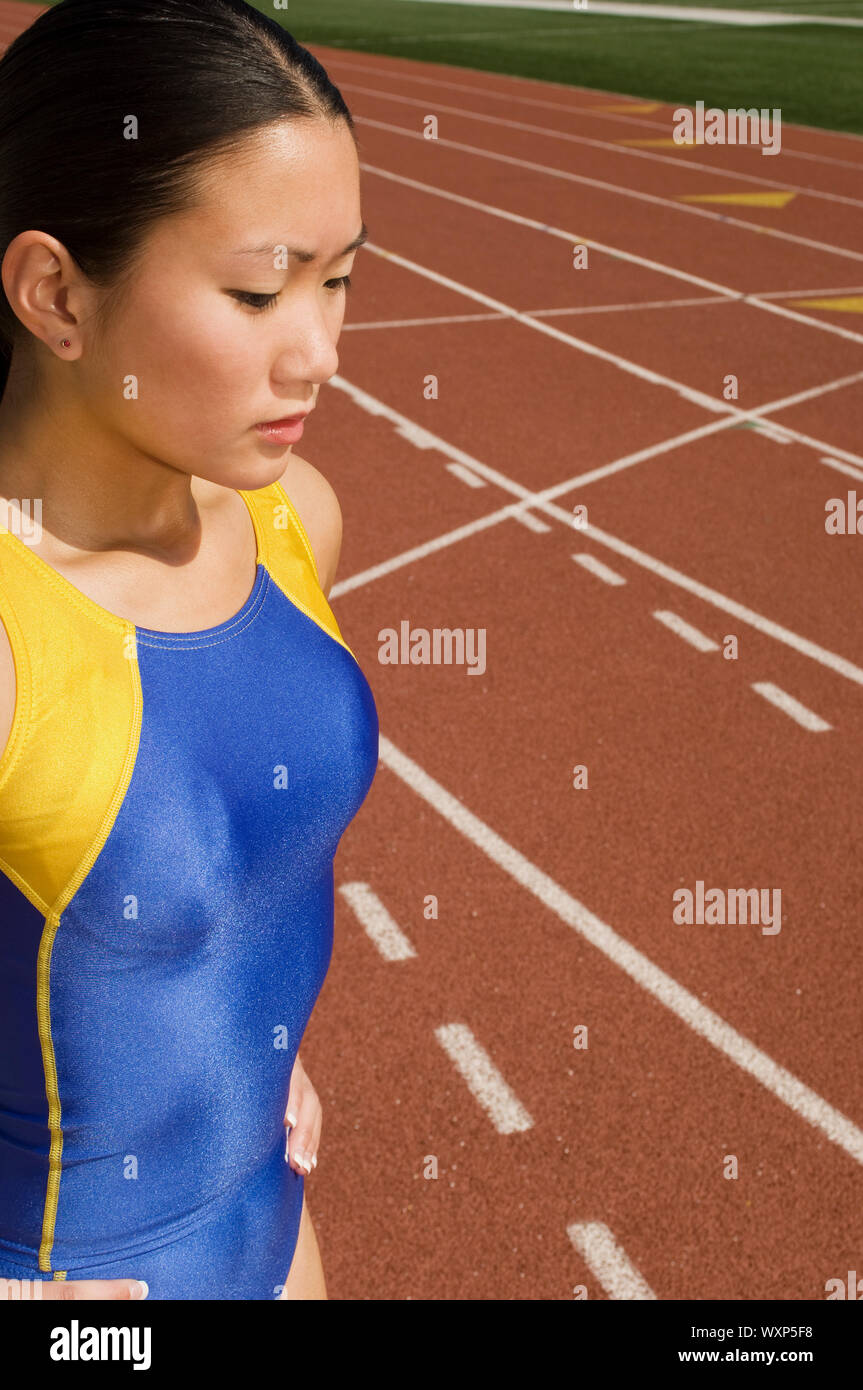 Female track athlete standing on track Stock Photo - Alamy