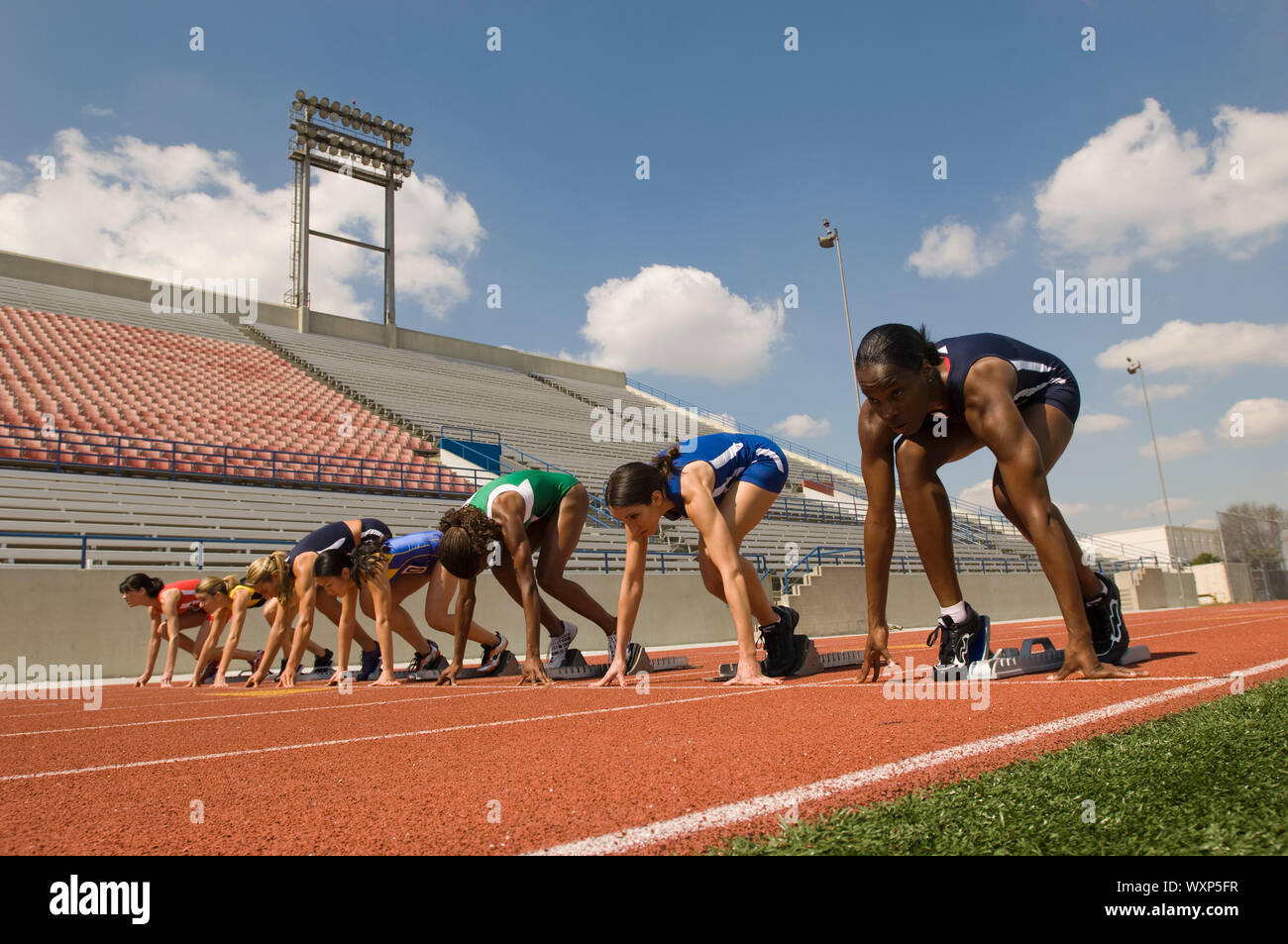Female athletes in starting blocks hi-res stock photography and images ...