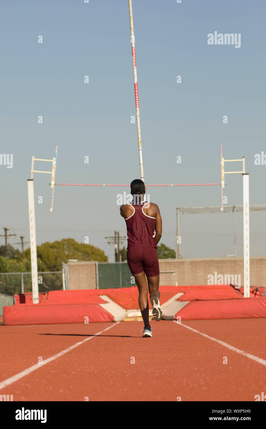 Female athlete preparing for pole jump Stock Photo - Alamy