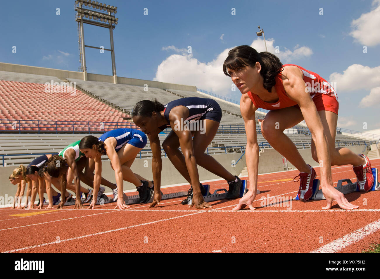 Female athletes in starting blocks hi-res stock photography and images ...