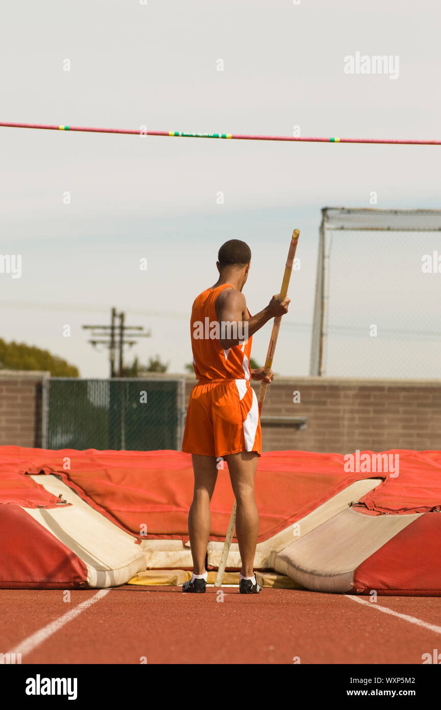 Pole-vaulter preparing for jump Stock Photo - Alamy