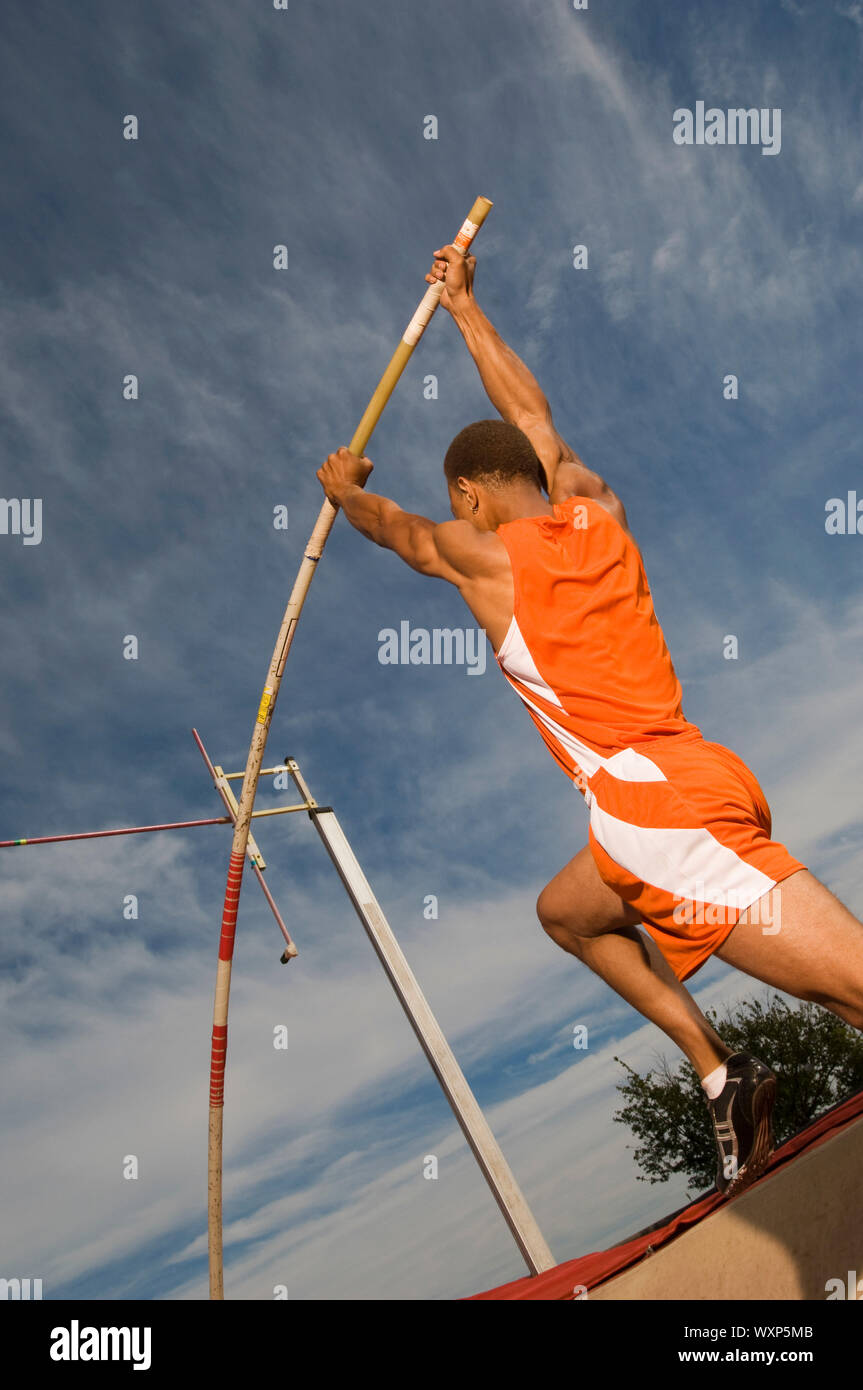 Pole vaulted taking off Stock Photo - Alamy