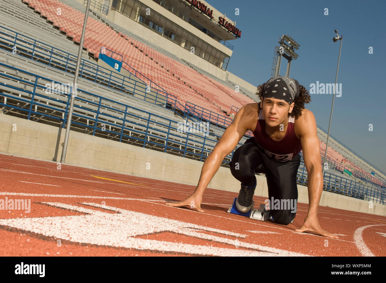 Runner on a track in starting block Stock Photo - Alamy