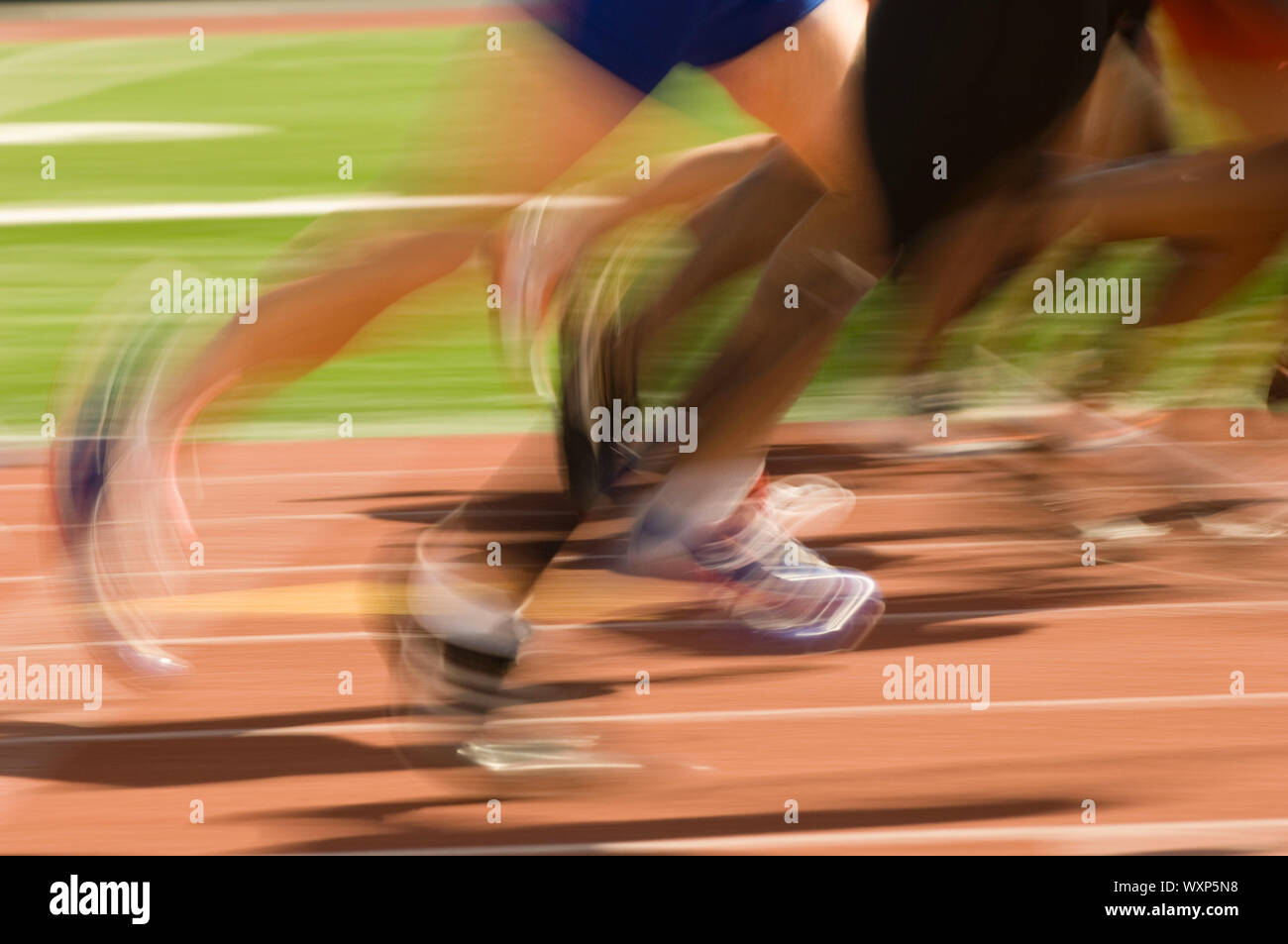 Low section of runners running on a track Stock Photo - Alamy