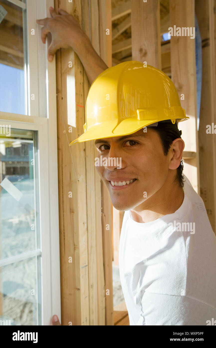 Construction worker installing window Stock Photo - Alamy