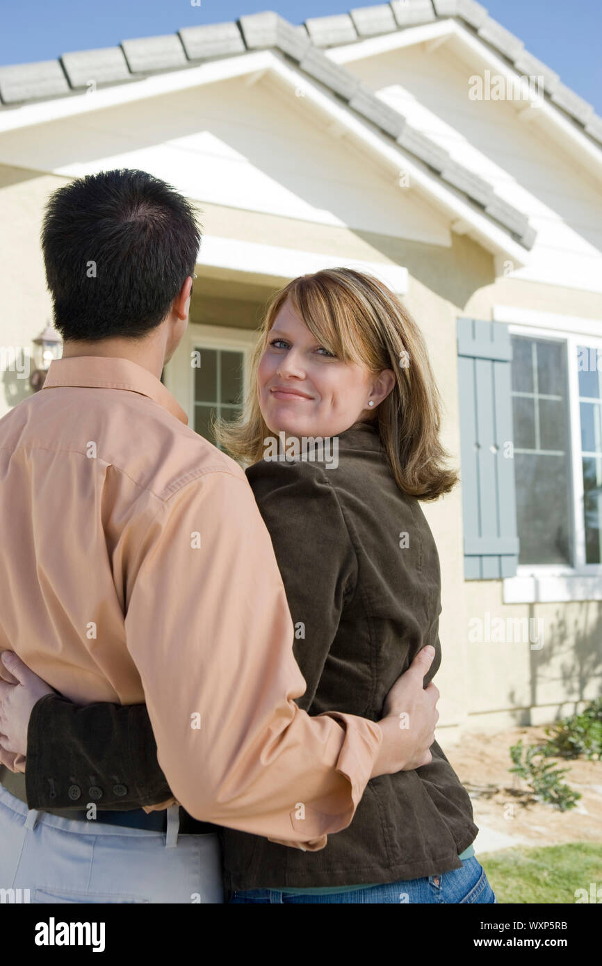 Couple admiring new house Stock Photo - Alamy