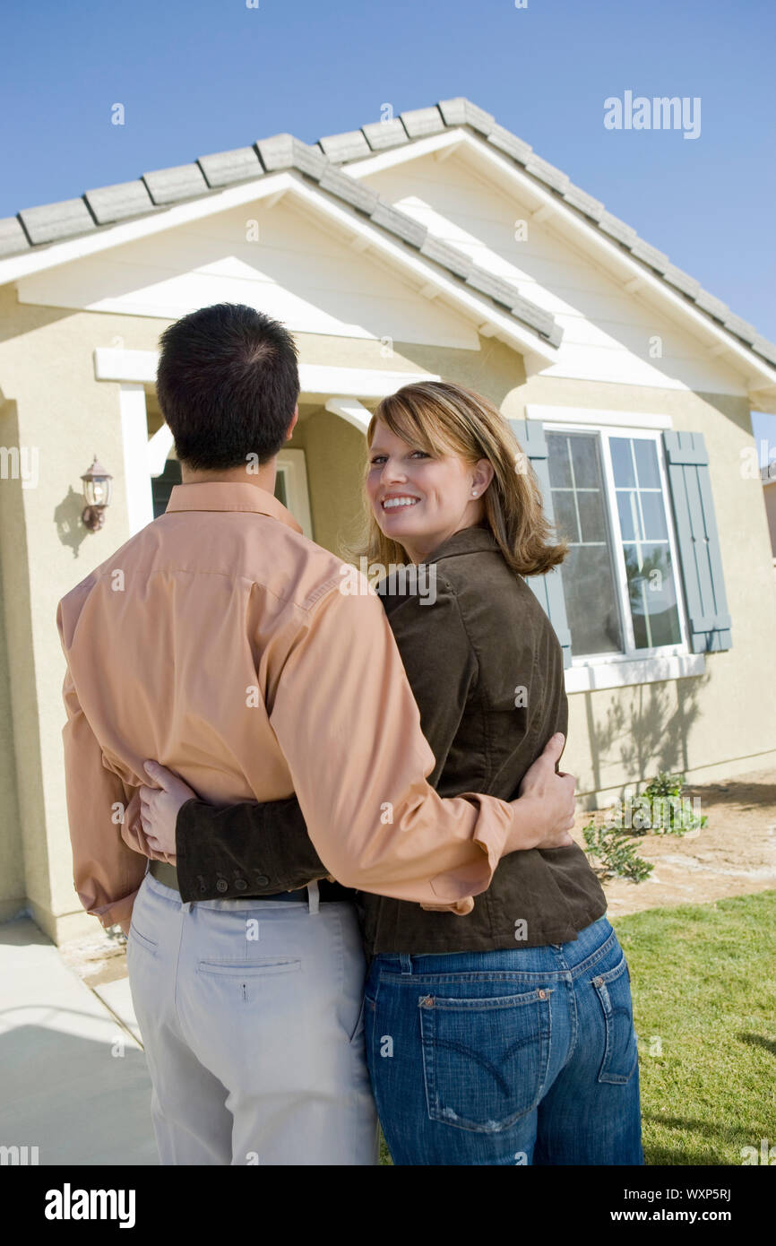 Couple admiring new house Stock Photo - Alamy