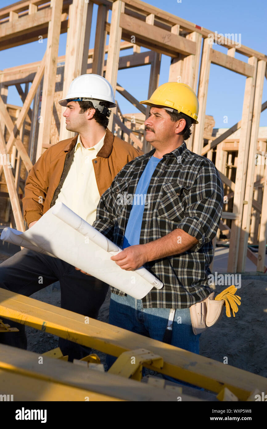 Architect with construction worker in construction site Stock Photo - Alamy