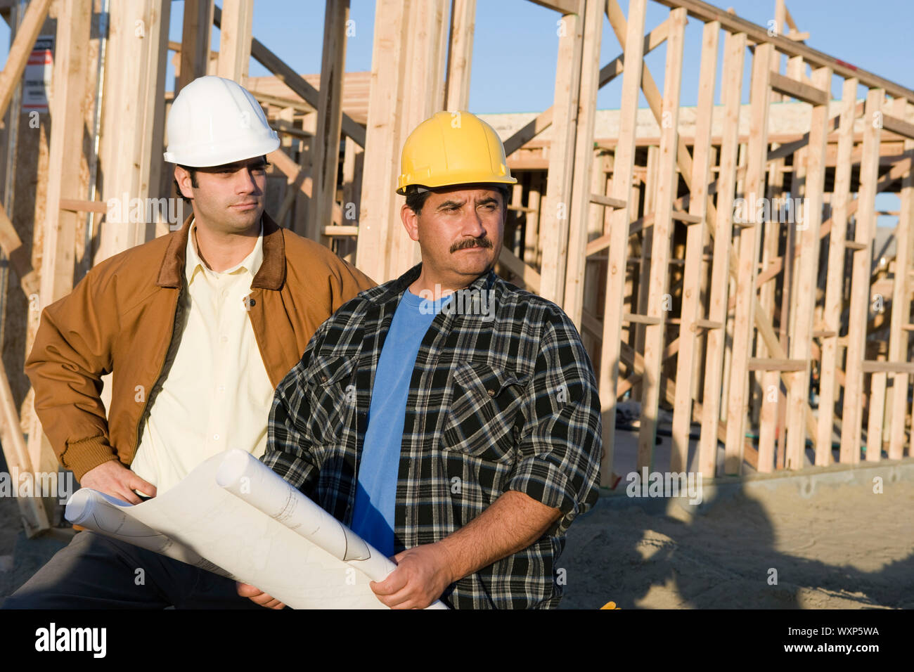 Architect with construction worker in construction site Stock Photo - Alamy