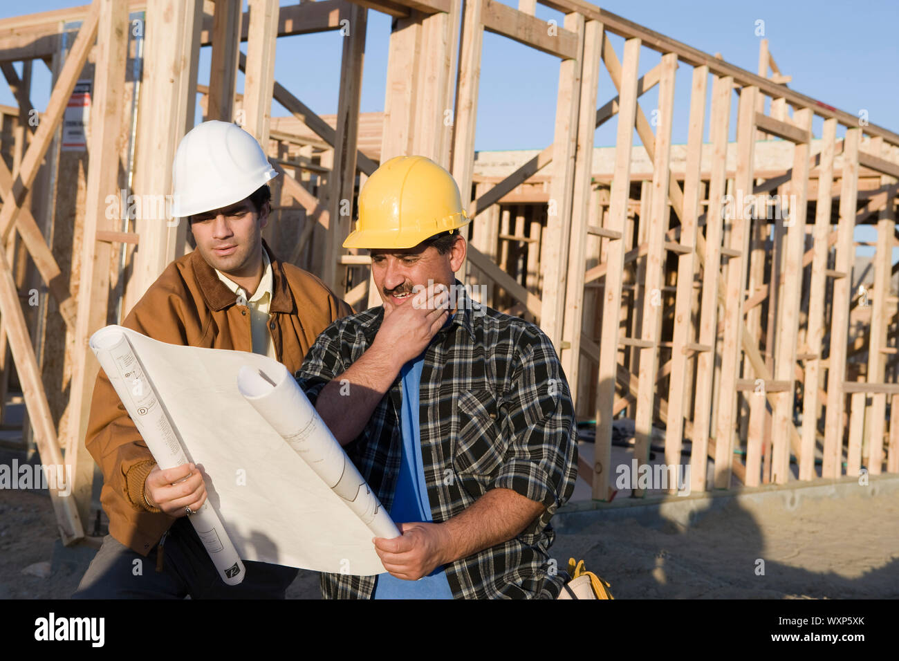 Architect with construction worker in construction site Stock Photo - Alamy