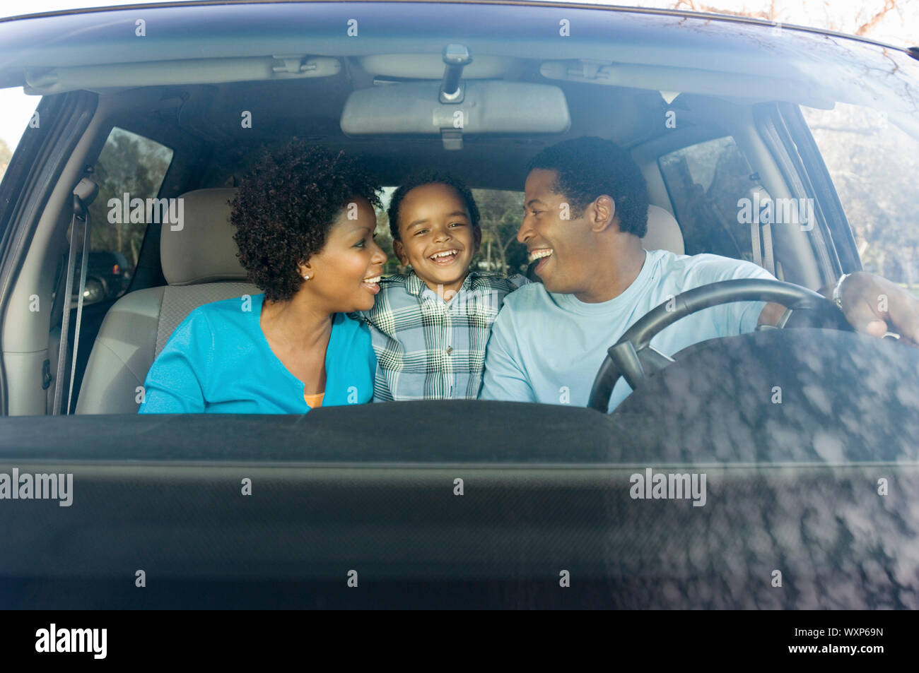 Family Sitting in Minivan Stock Photo - Alamy
