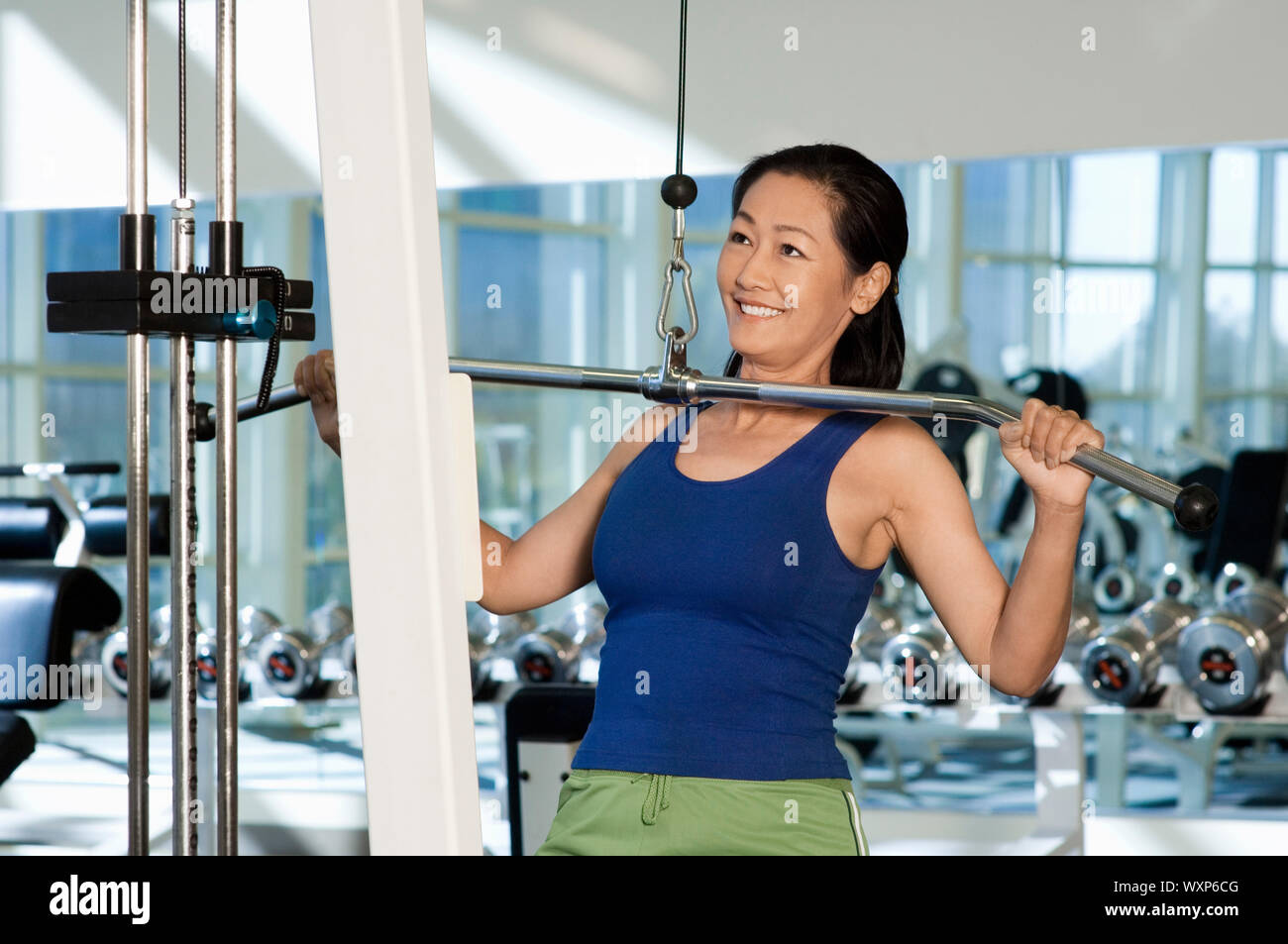 Woman Using Exercise Equipment Stock Photo - Alamy