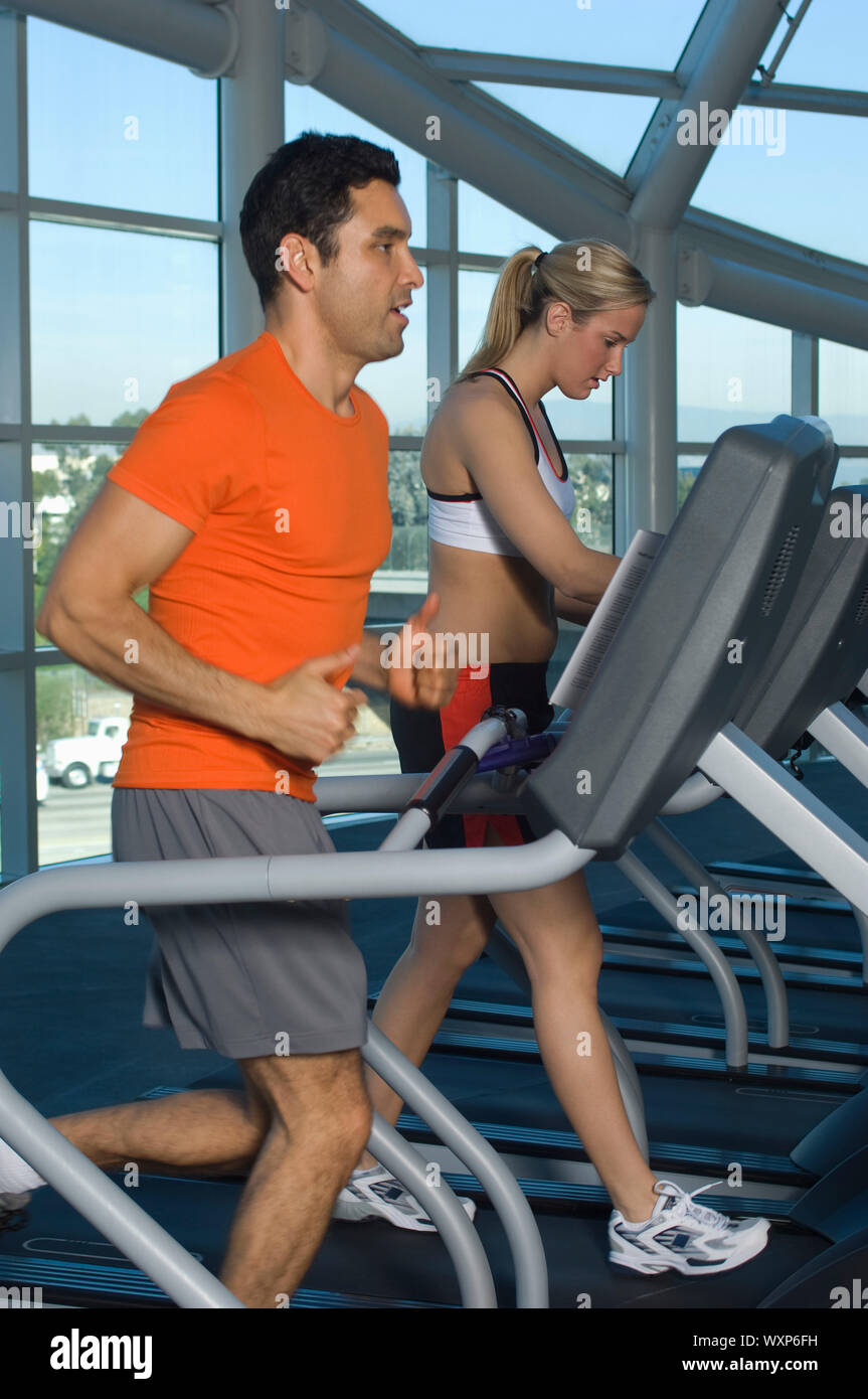 Woman man walking on treadmills hi-res stock photography and images - Alamy