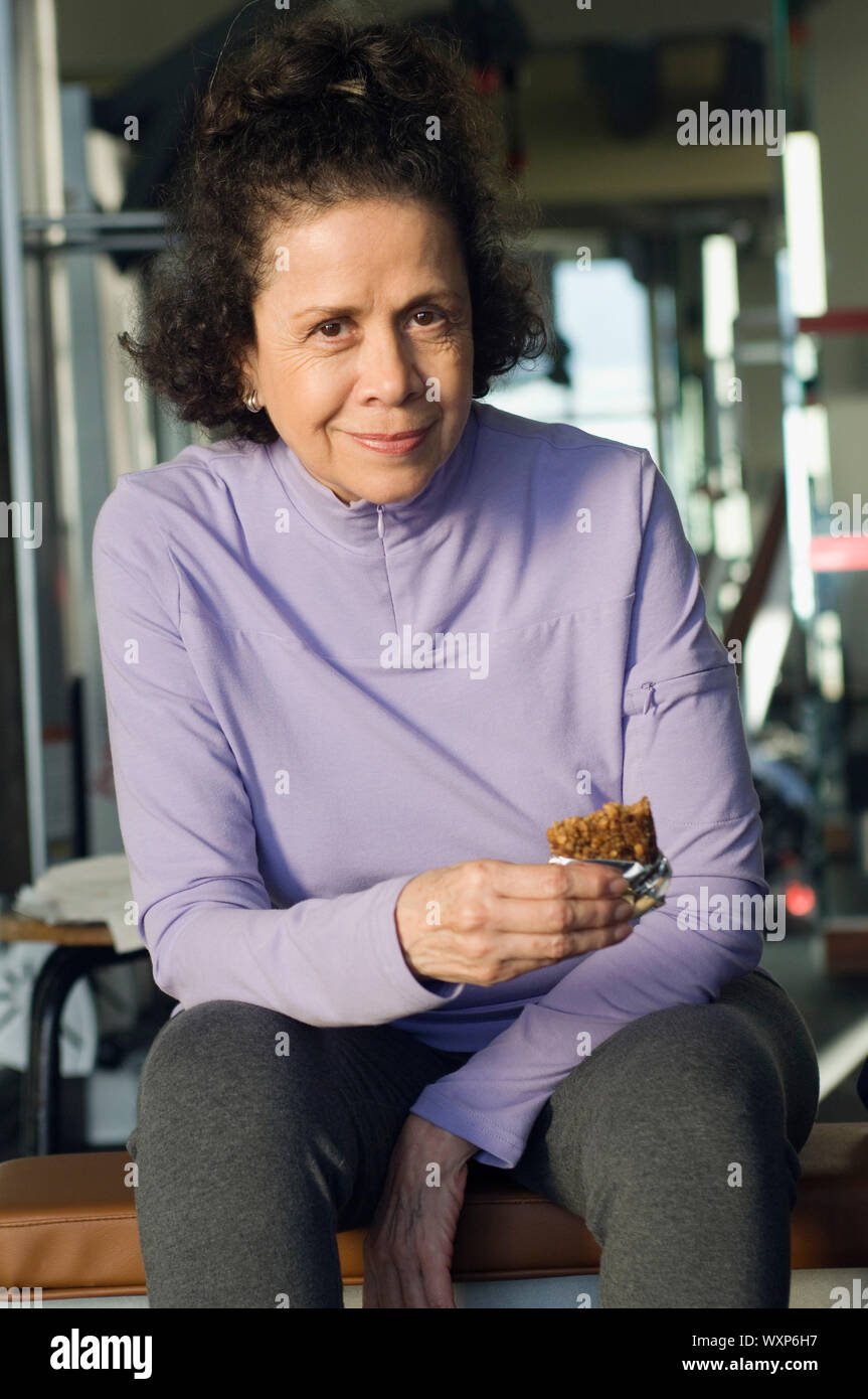 Woman eating exercise snack bar hi-res stock photography and images - Alamy