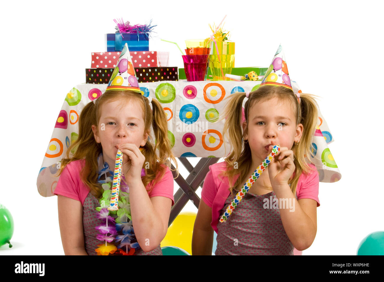 Girls with party blowers on a birthday party Stock Photo - Alamy