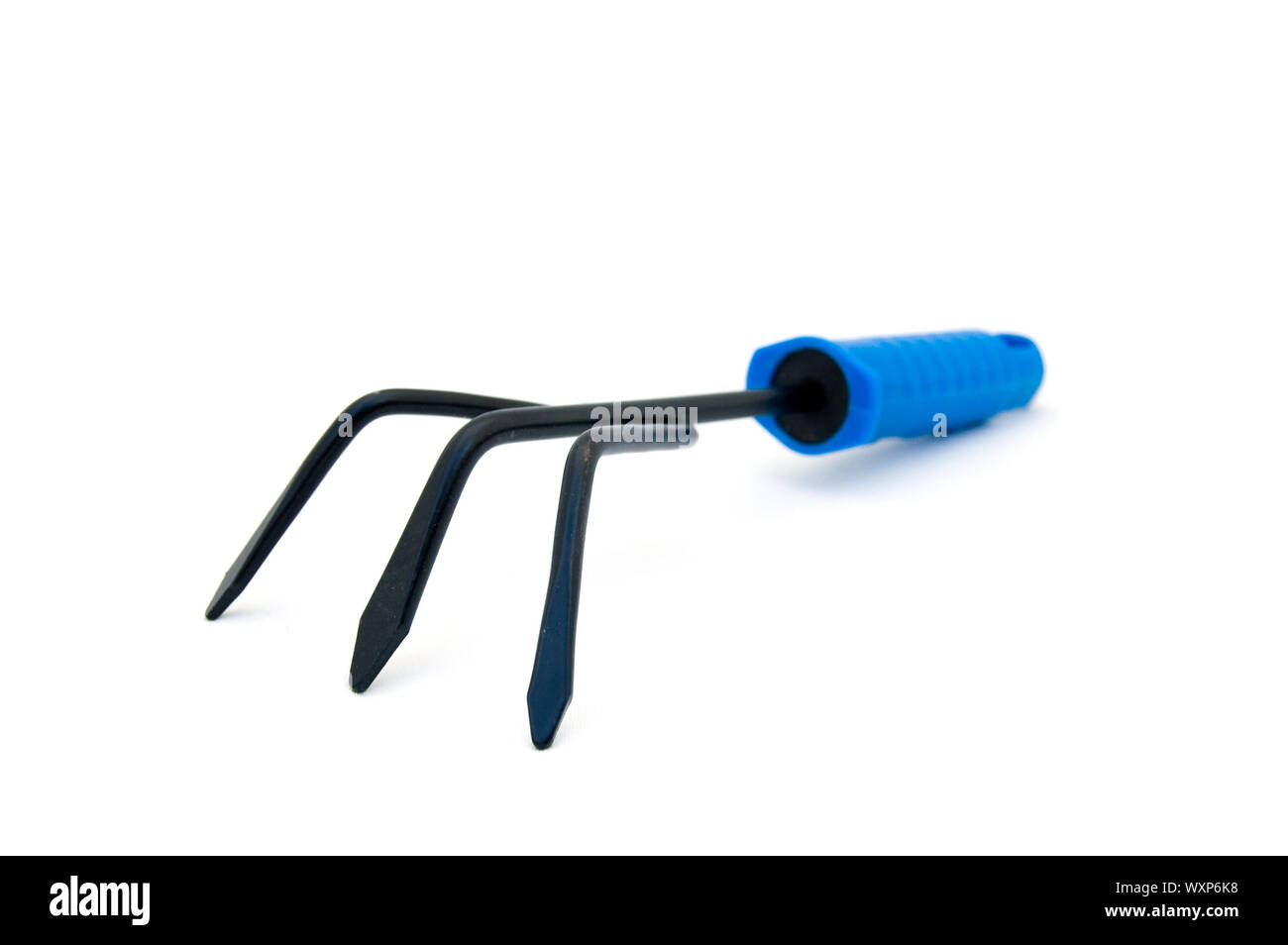 Rake used for gardening on a white background Stock Photo - Alamy