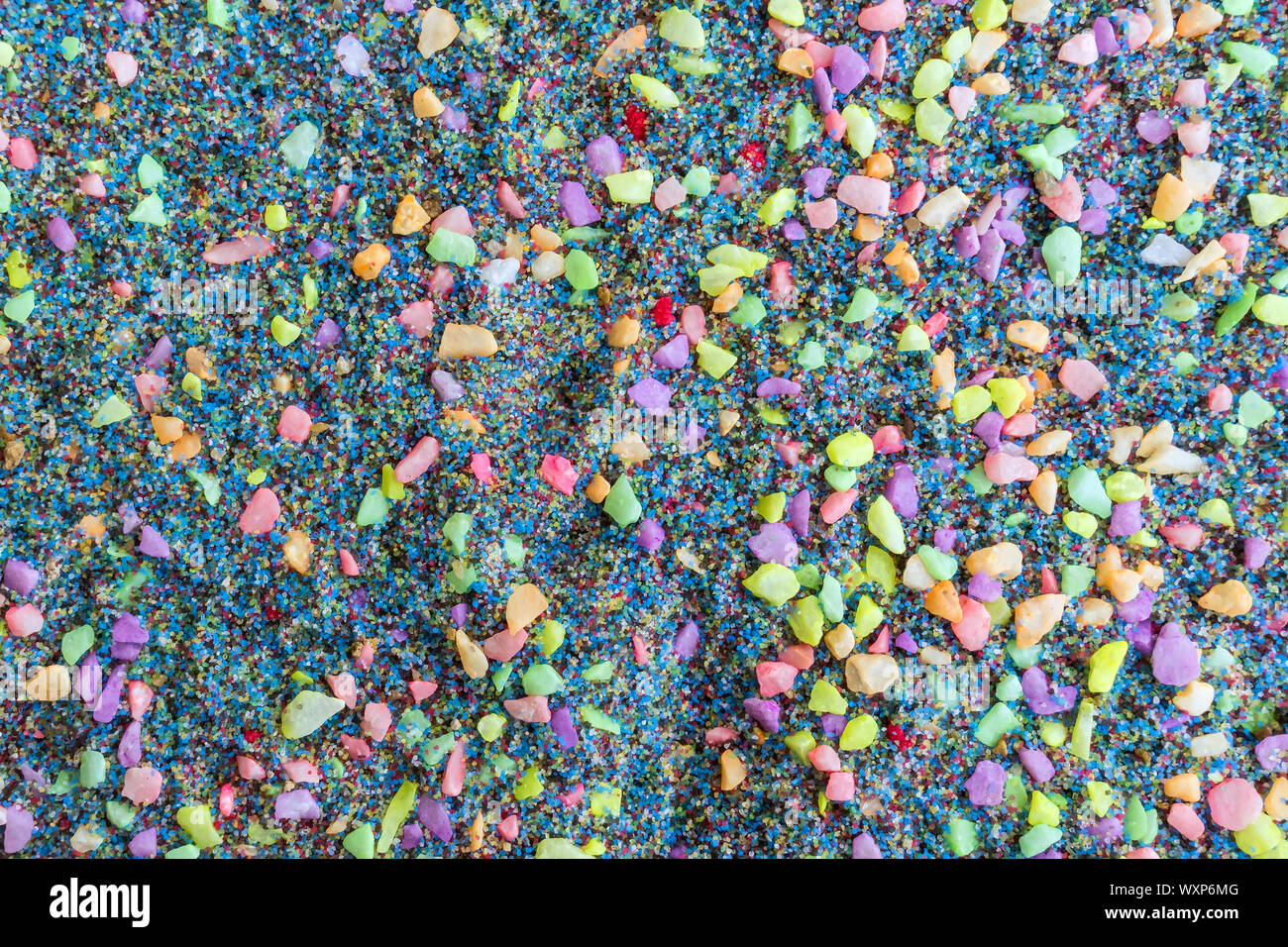 Top view with background of multi-colored small pebbles. Multi-colored ...