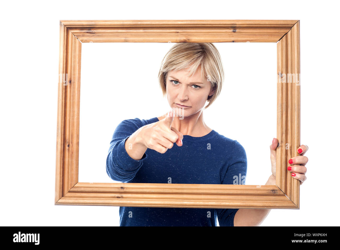 Woman holding photo frame serious hi-res stock photography and images ...