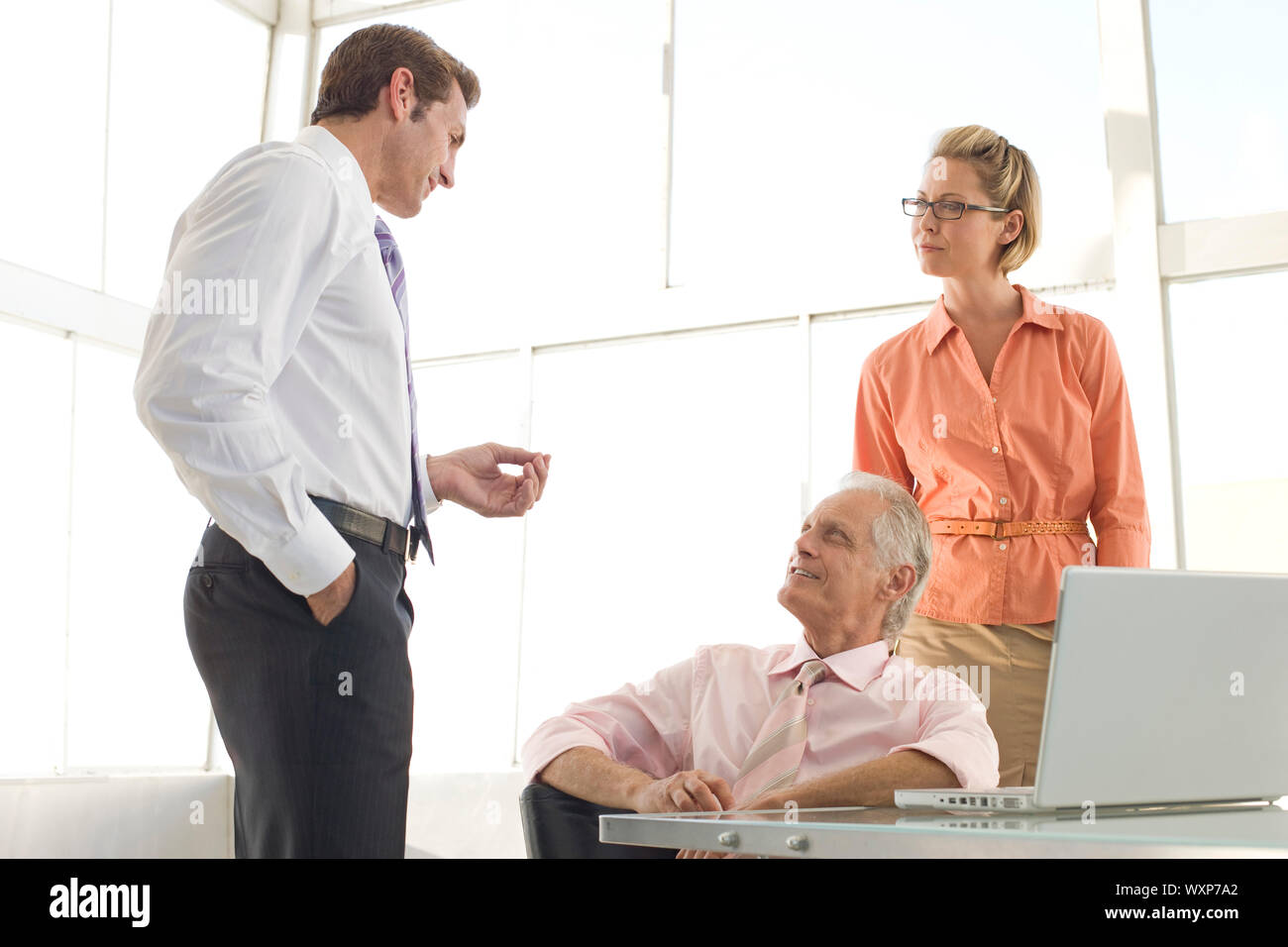Male executive having discussion with colleagues in meeting room Stock ...