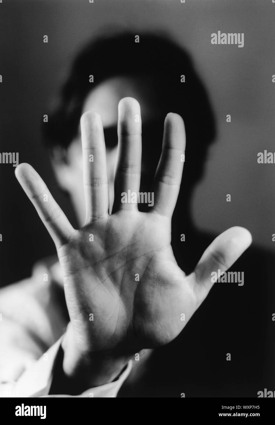 Hand Blocking Man's Face Stock Photo - Alamy