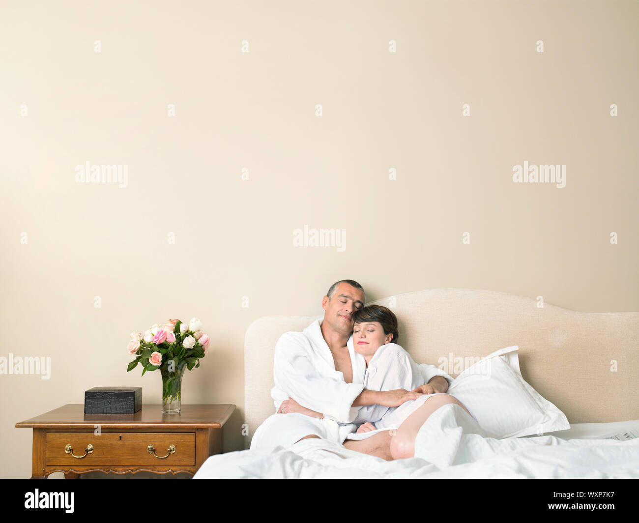 Loving couple sleeping together in bed Stock Photo - Alamy
