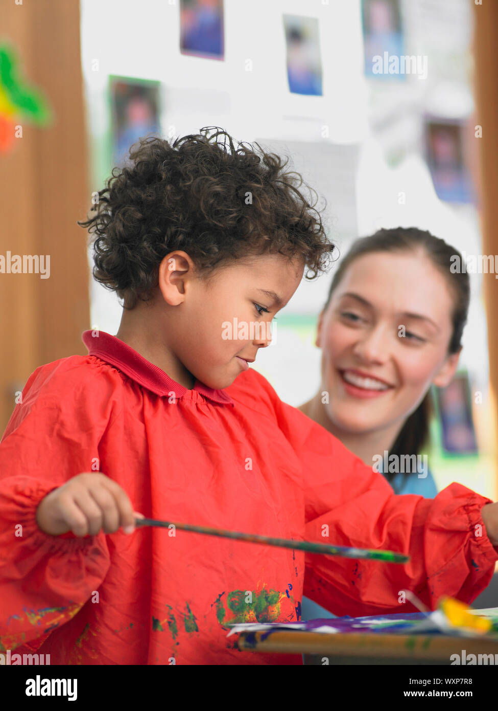 Elementary Student and Teacher in Art Class Stock Photo - Alamy