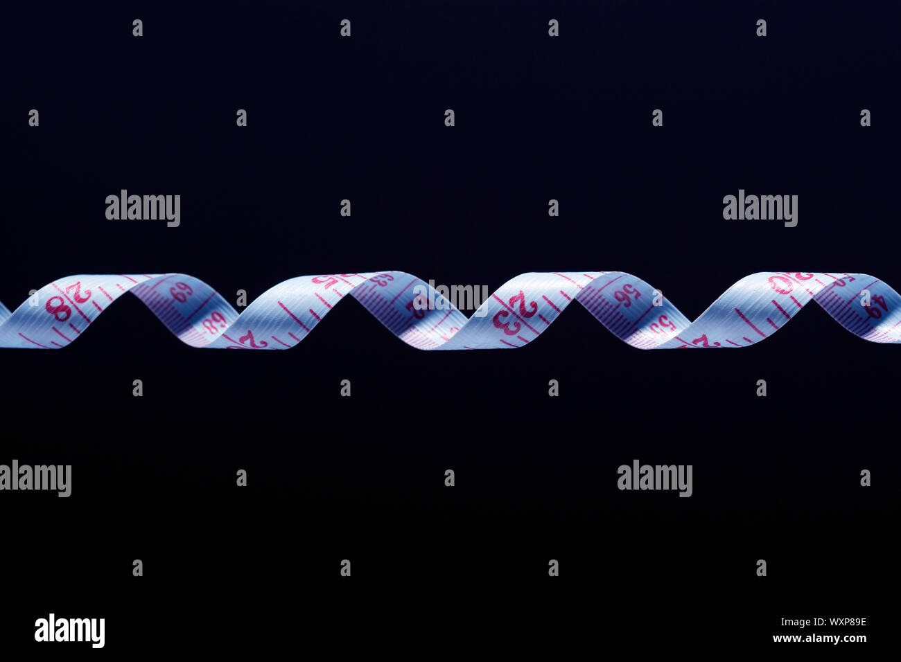 Twisted Strip of Measuring Tape Stock Photo - Alamy