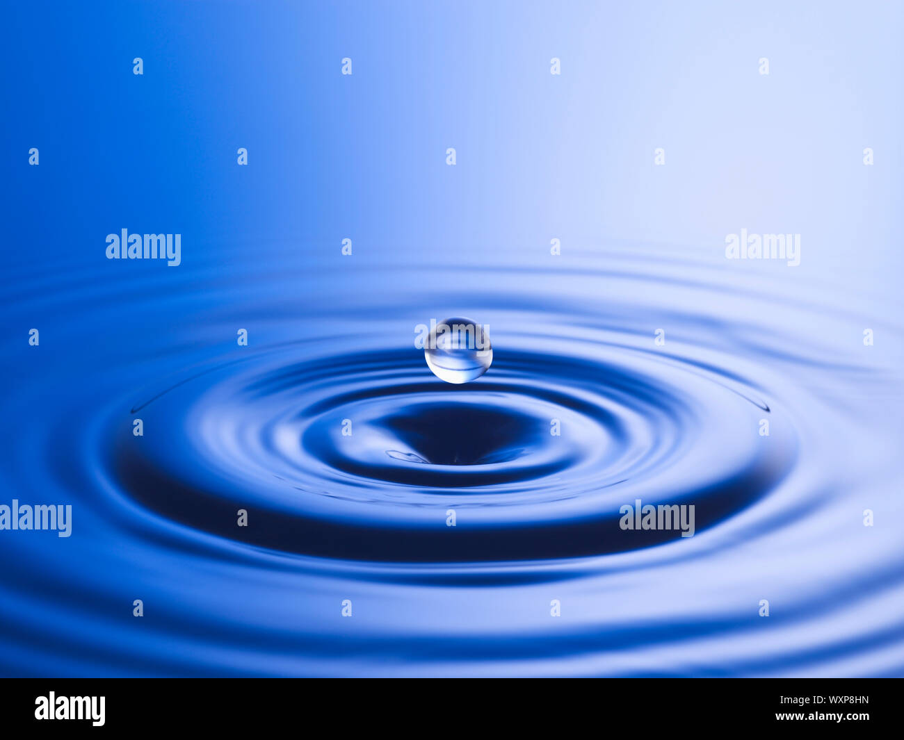 Drop hitting surface of water close-up Stock Photo - Alamy