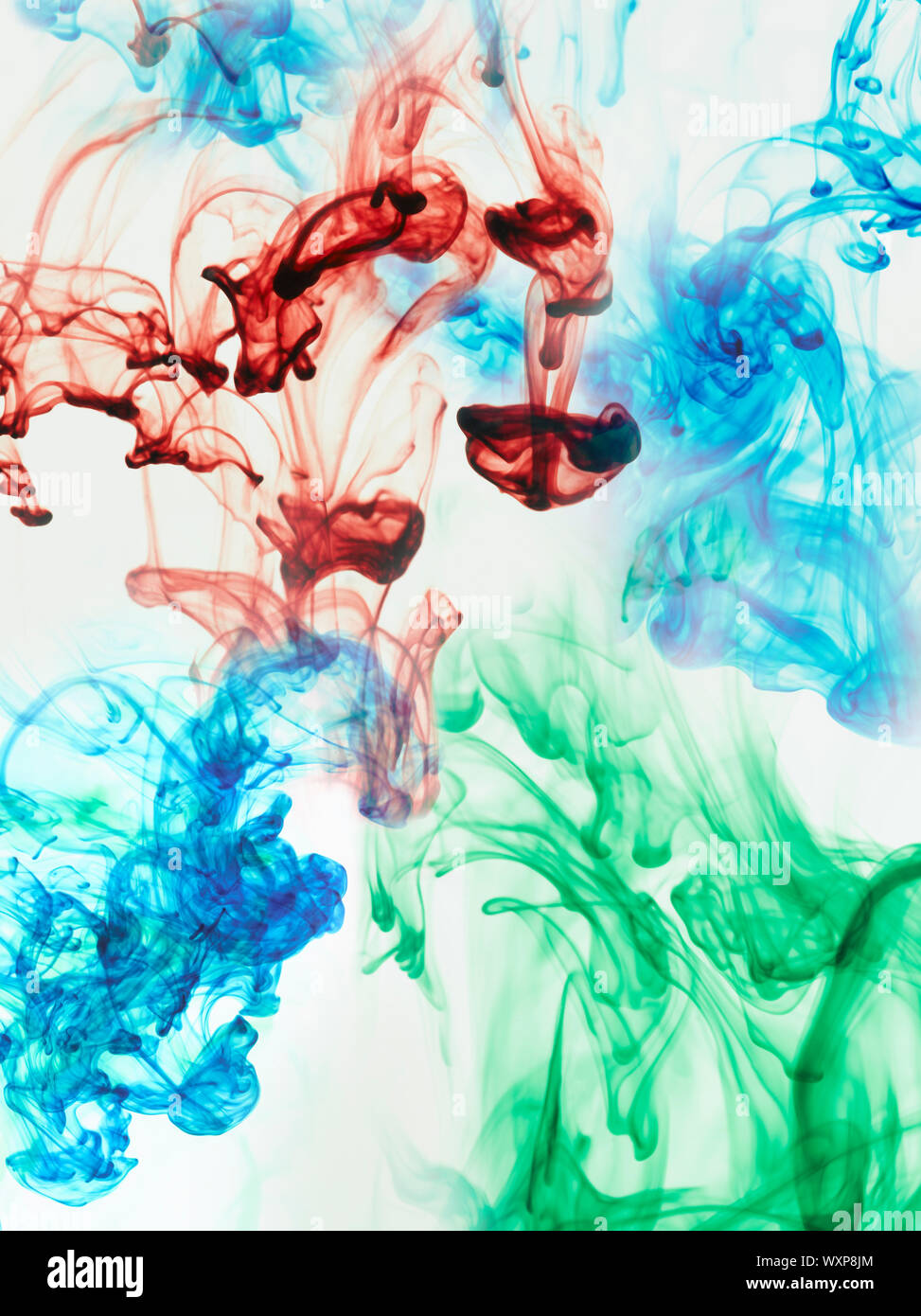 Multi-coloured substances dissolving in water Stock Photo - Alamy