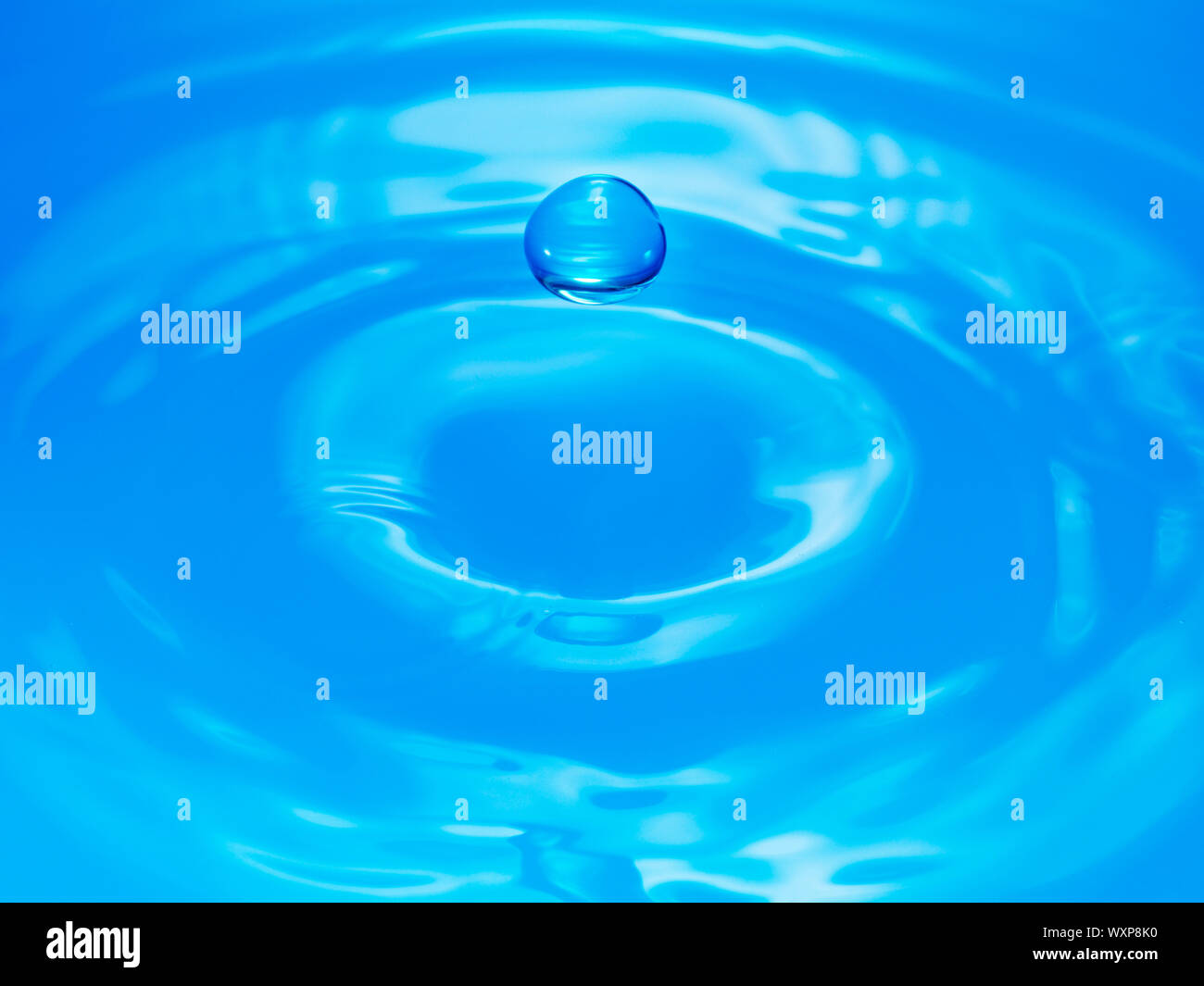 Drop hitting surface of water close-up Stock Photo - Alamy
