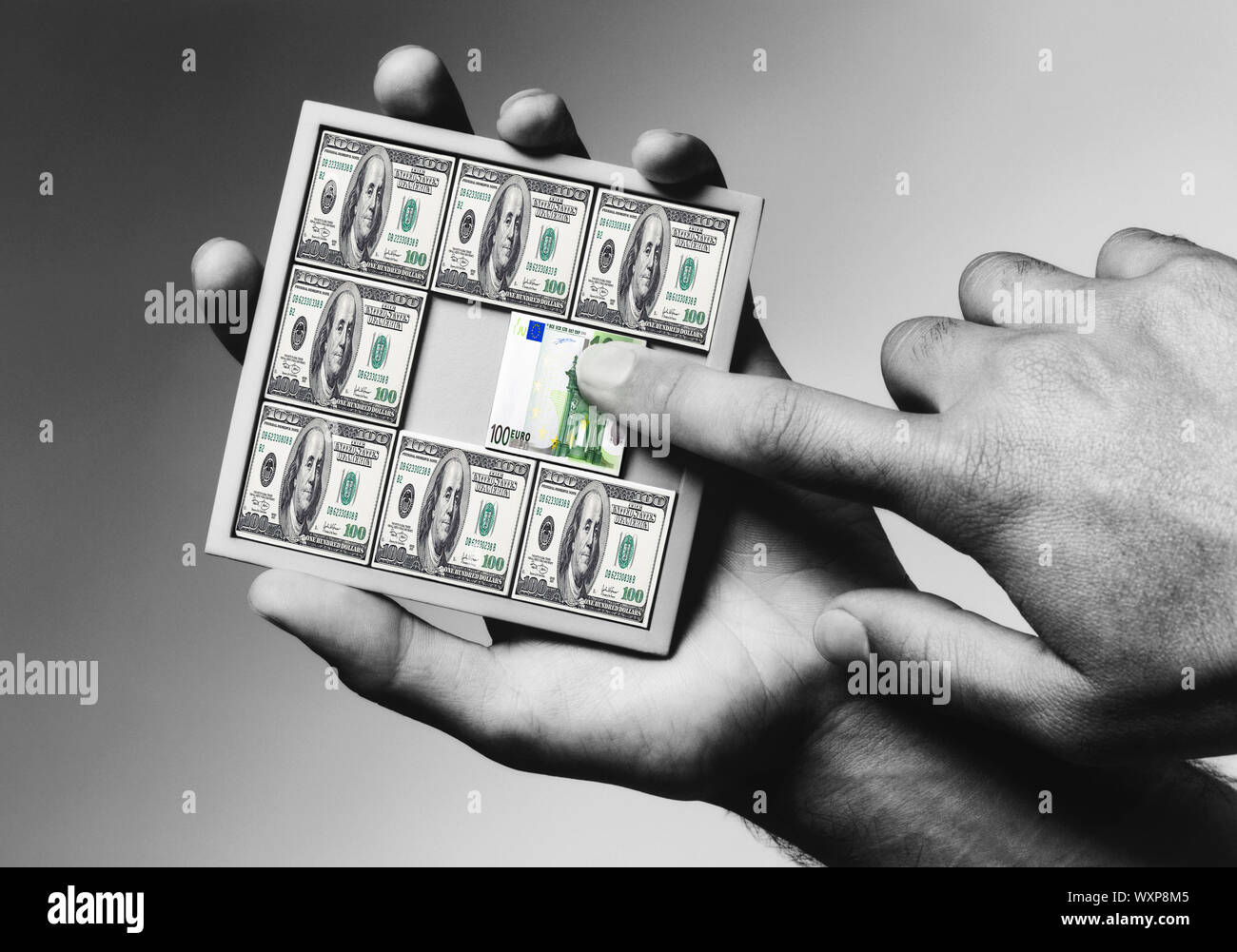 Man holding sliding tile puzzle with tiles representing various ...