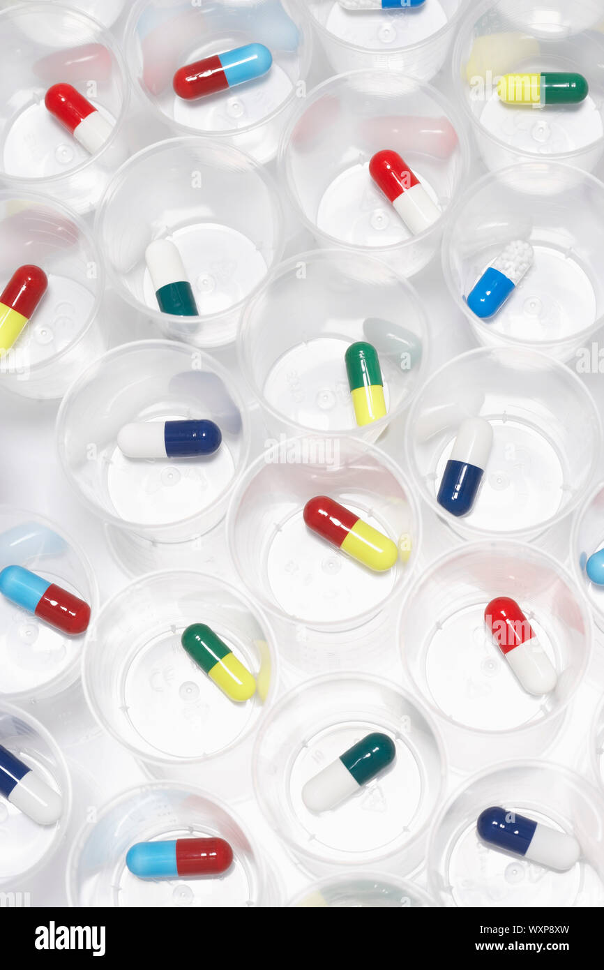 Capsule pills in plastic cups Stock Photo - Alamy