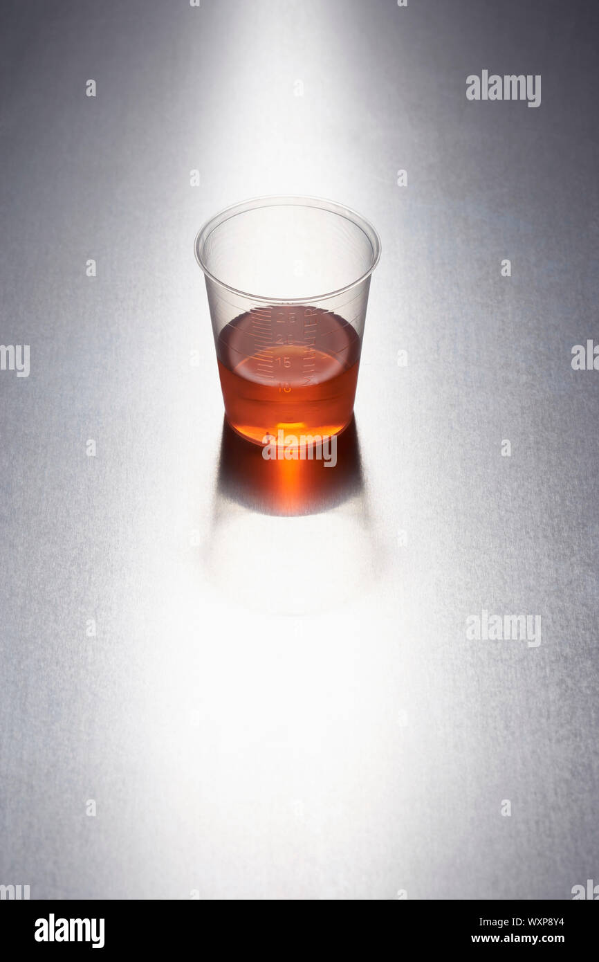 Medication in plastic cup Stock Photo - Alamy