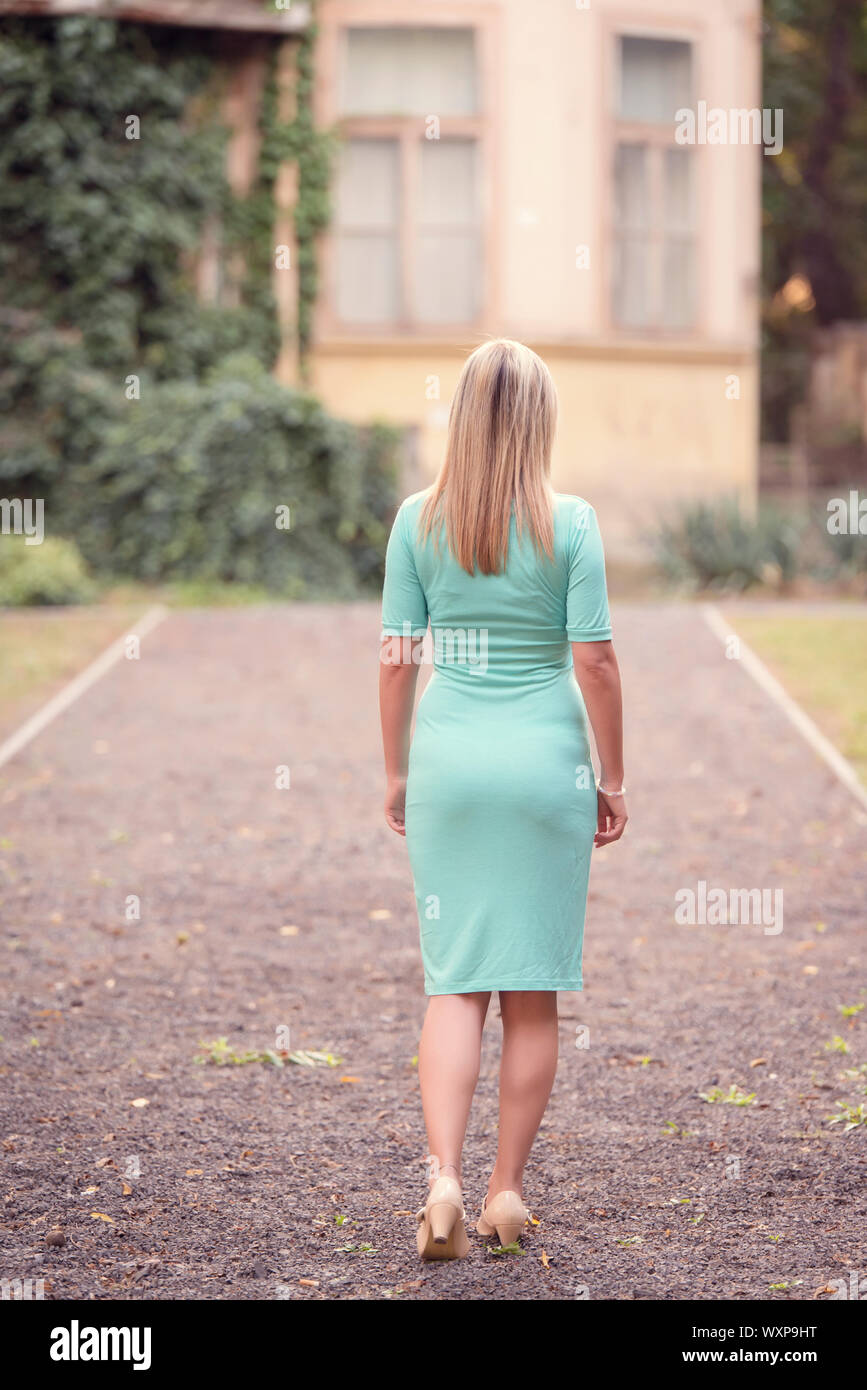 Back view of a pretty woman. Woman go to home Stock Photo - Alamy